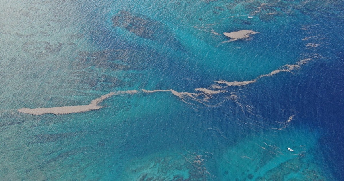 A photo taken by the drone shows patterns of pumice rafts across the ...