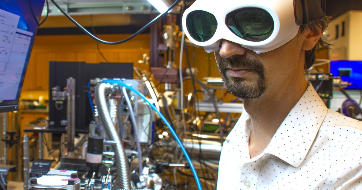 Scientist in the Femtosecond Spectroscopy Unit adjusts laser settings ...